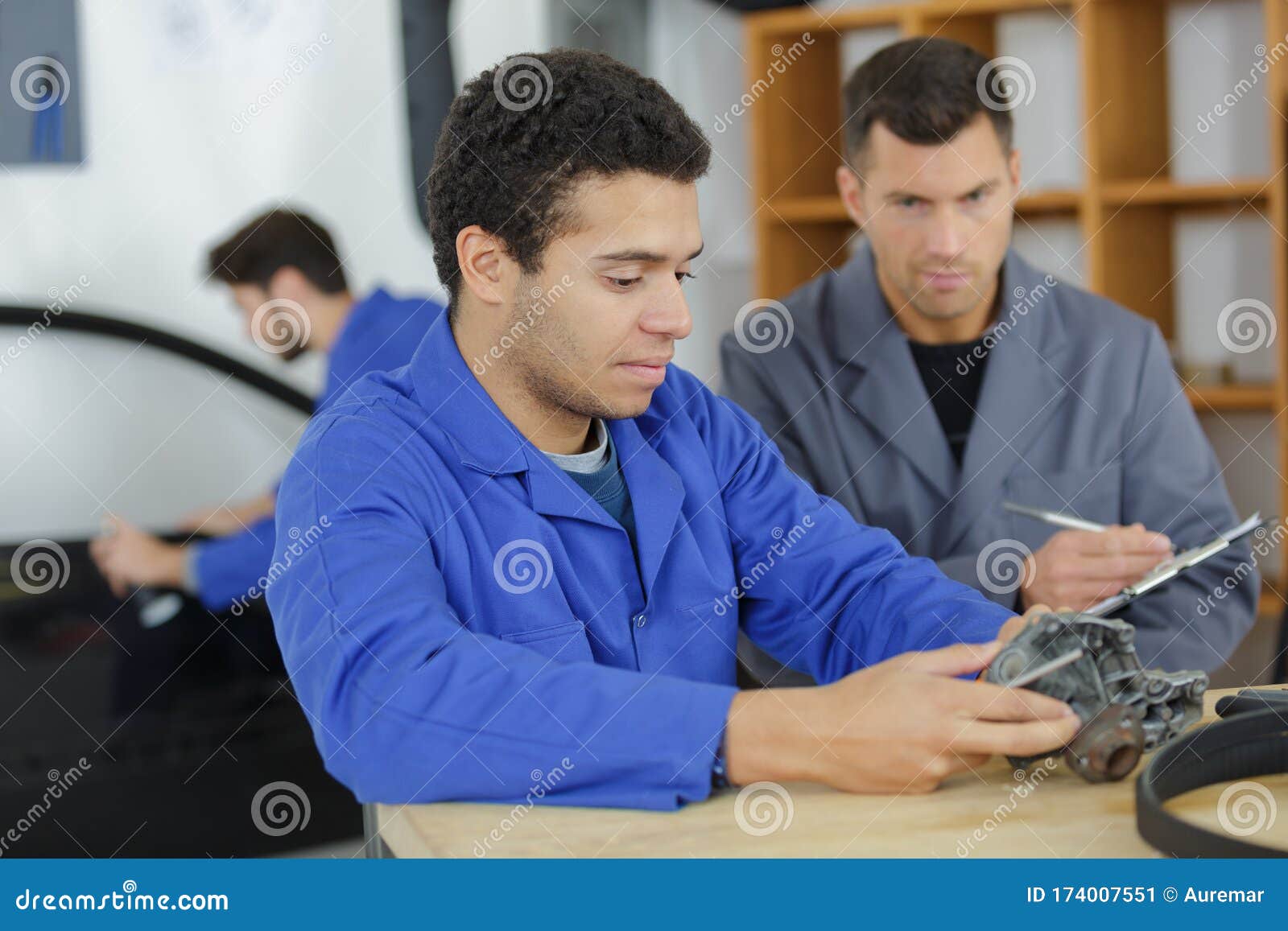 Teacher Observing Student with Mechanical Parts Stock Image - Image of ...