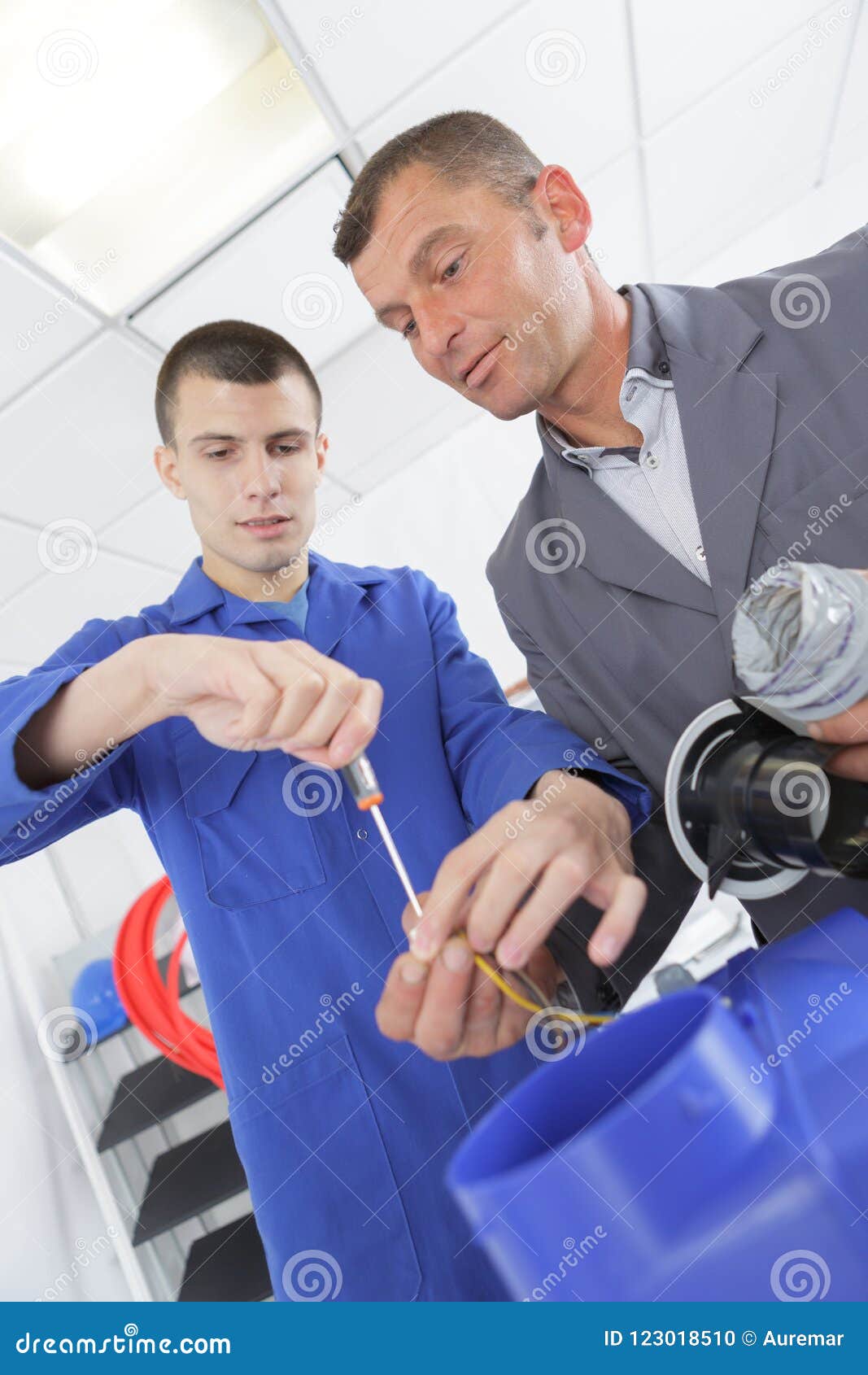 Teacher Observing Student Working on Electrical Circuits Stock Photo ...