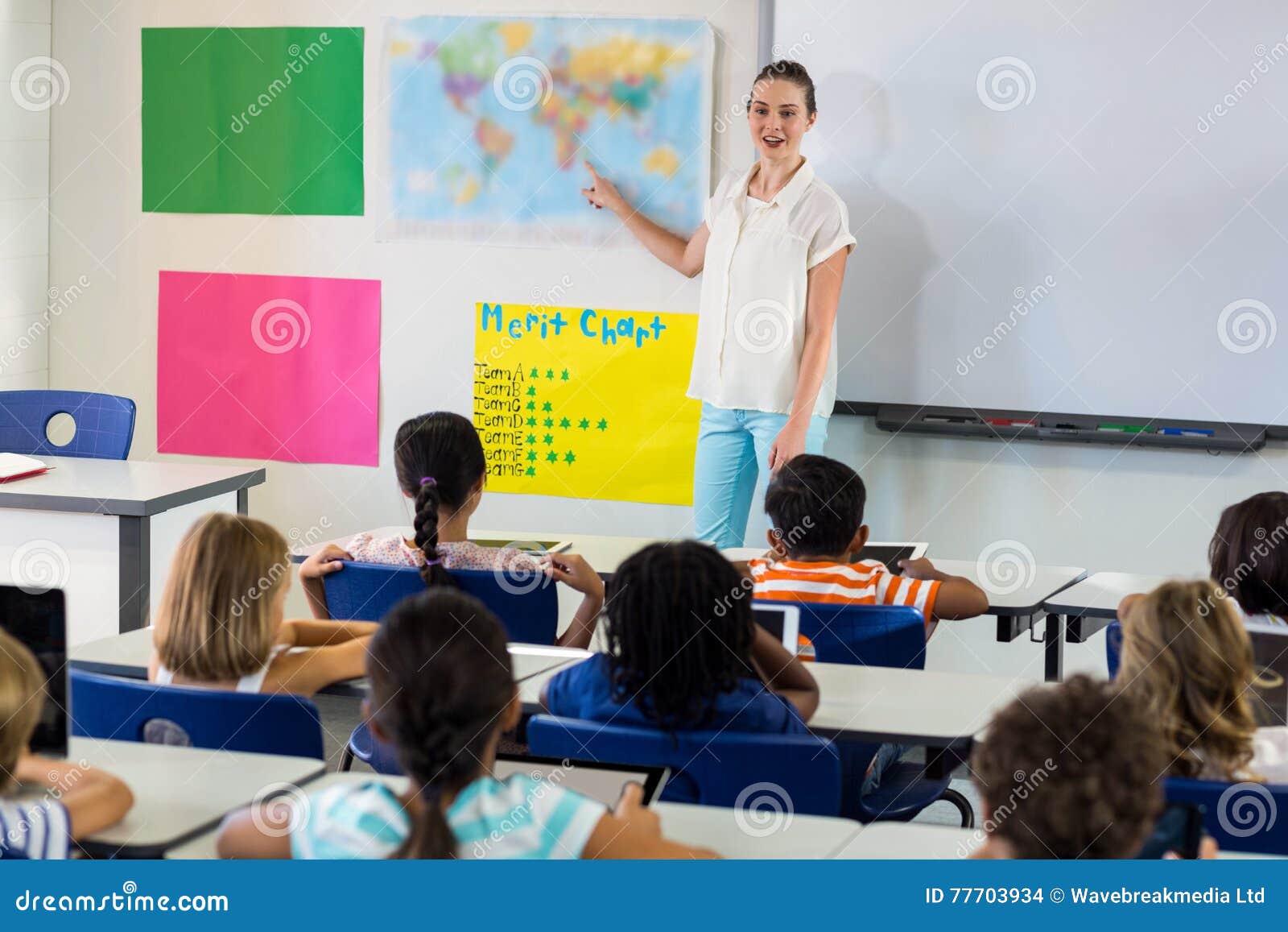 Teacher Pointing on Map while Teaching Children Stock Photo - Image of ...