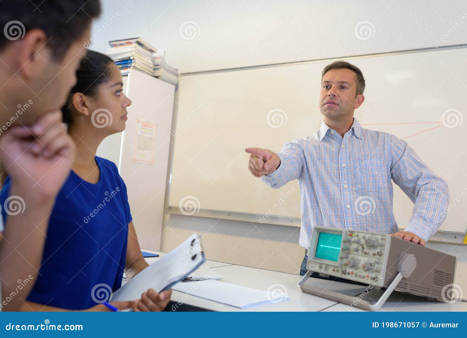 Teacher Pointing at Students in Classroom Stock Image - Image of ...