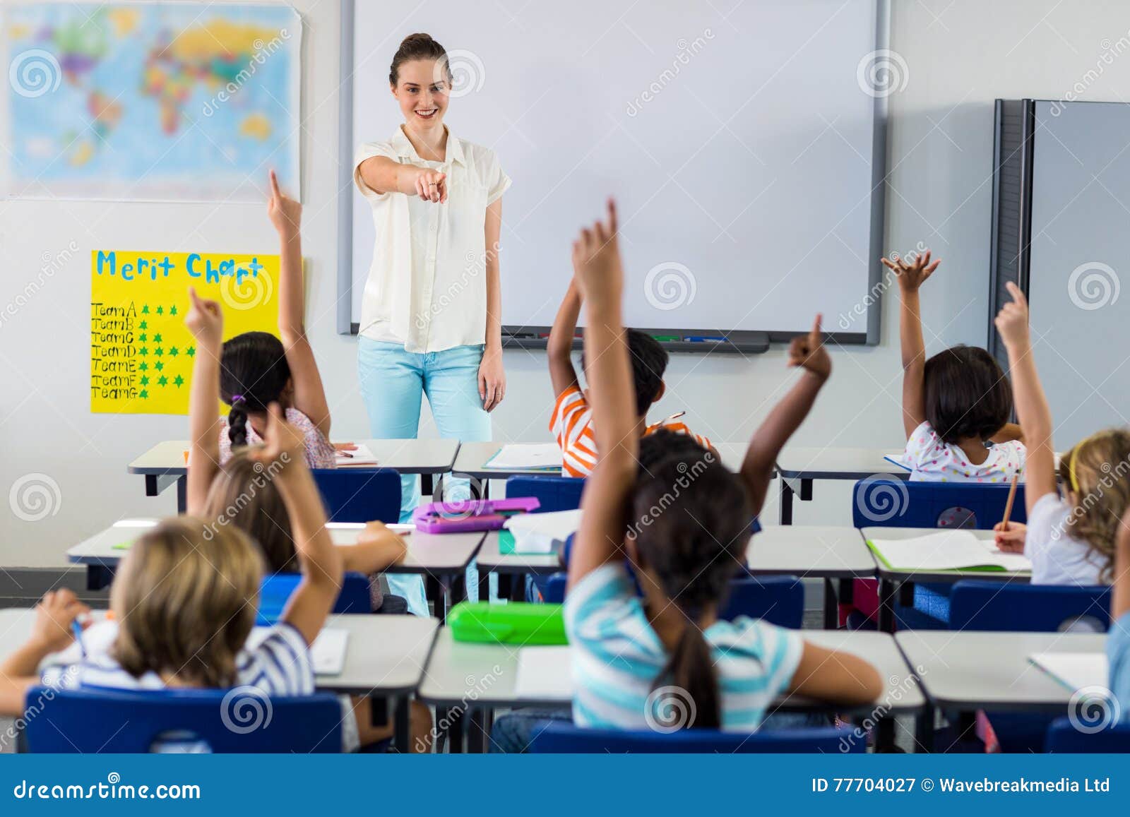 Teacher Pointing Students with Raised Hands Stock Image - Image of ...