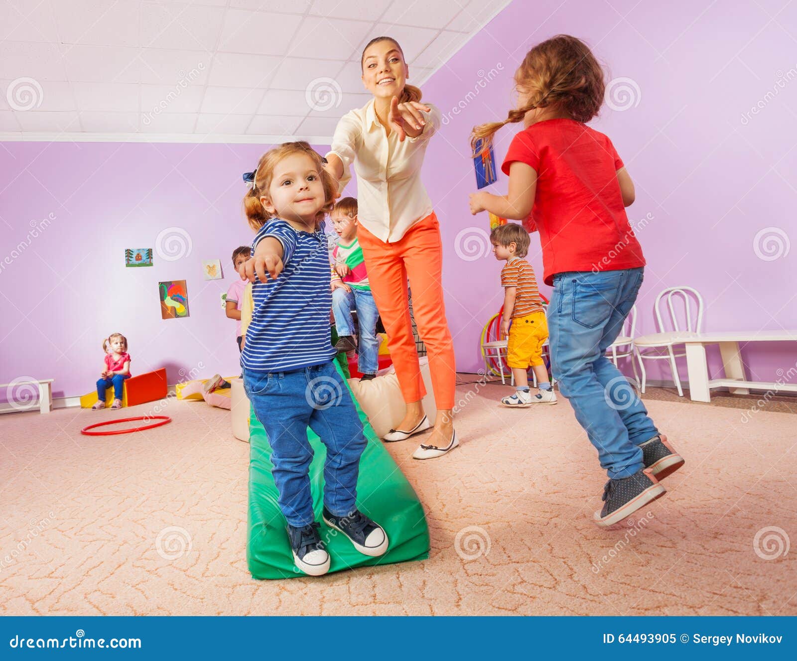 Teacher Points Running and Jumping Kids To Viewer Stock Image - Image ...