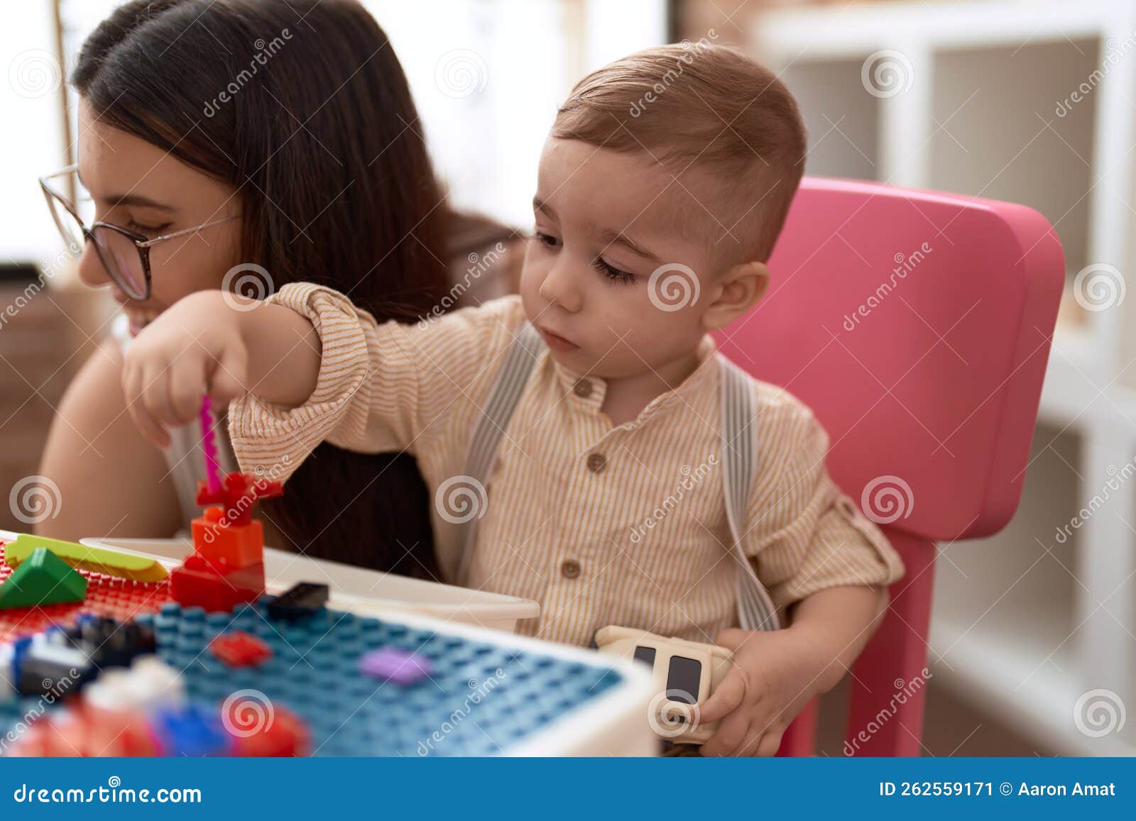 Teacher and Preschool Student Playing with Construction Blocks Sitting ...