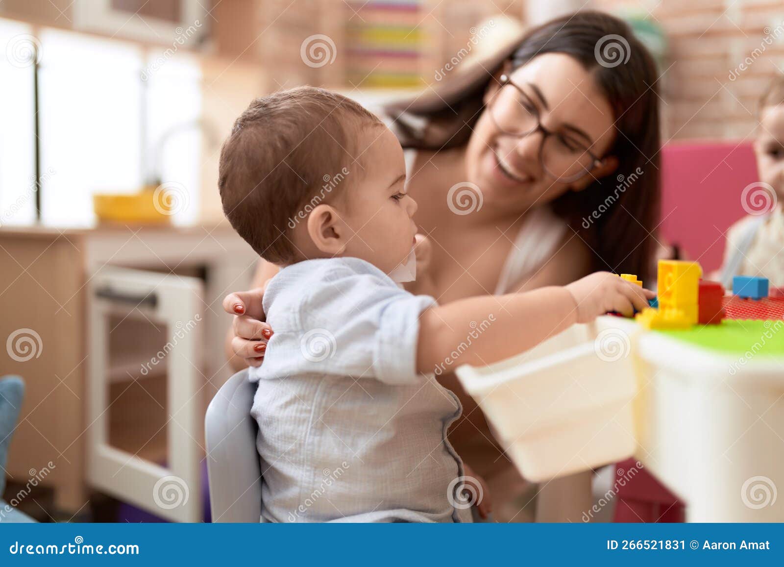 Teacher and Preschool Student Playing with Construction Blocks Sitting ...