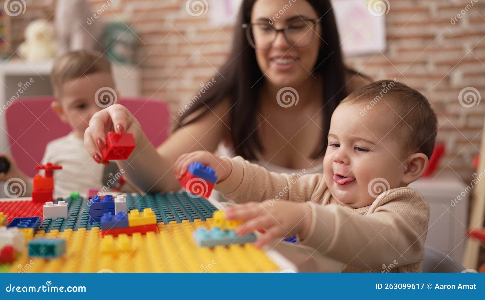 Teacher and Preschool Students Playing with Construction Blocks Sitting ...