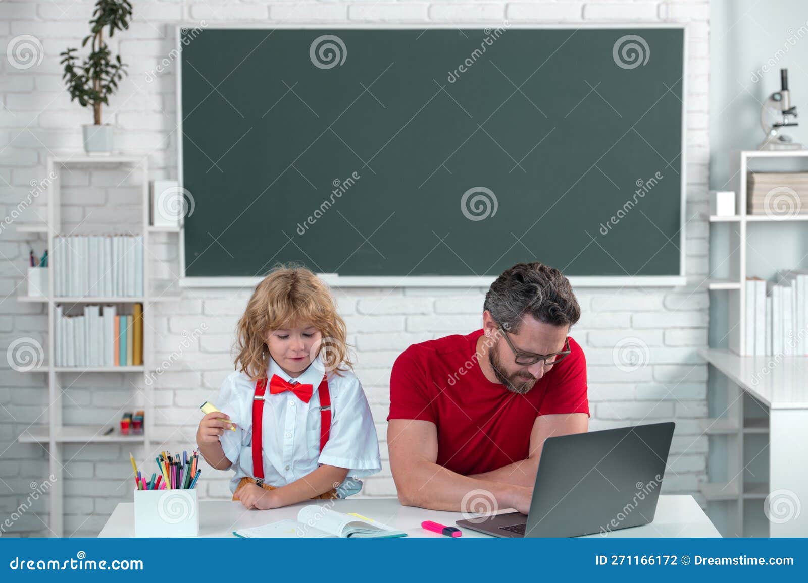 Teacher and Pupil Boy Learning in the Classroom. Elementary School Boy ...