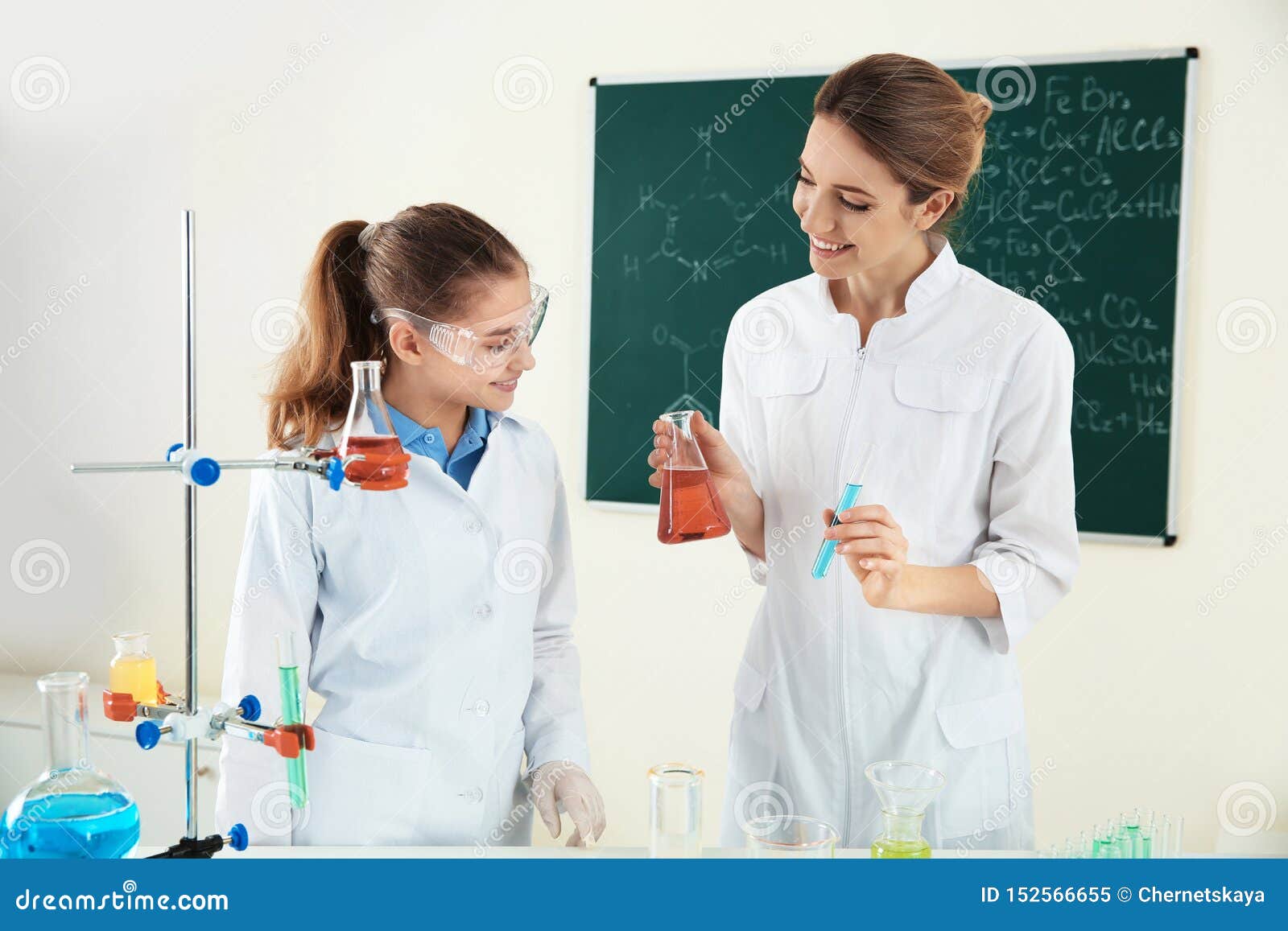 Teacher with Pupil Making Experiment Stock Image - Image of girl ...