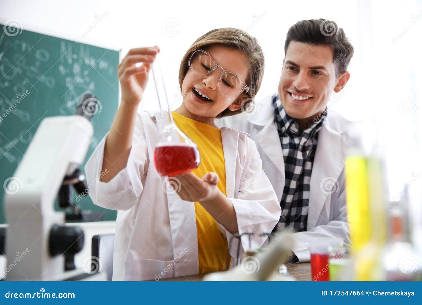 Teacher with Pupil Making Experiment in Class Stock Photo - Image of ...