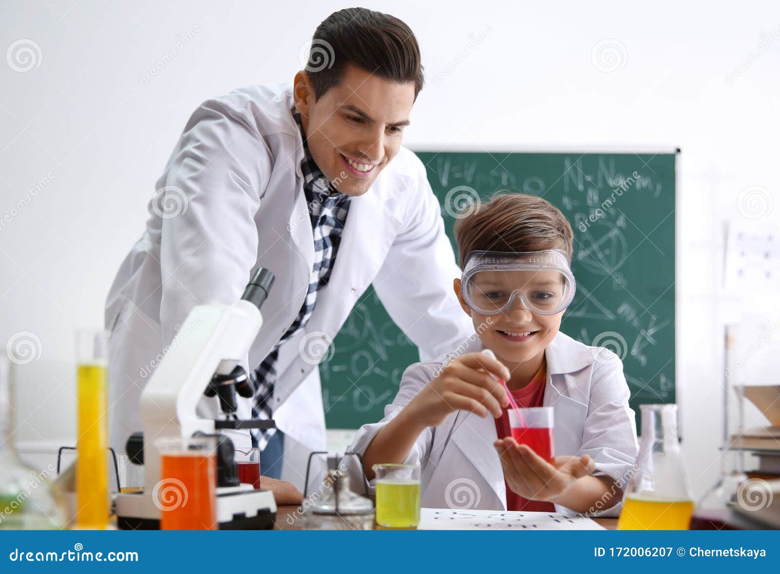 Teacher with Pupil Making Experiment at Table in Class Stock Image ...