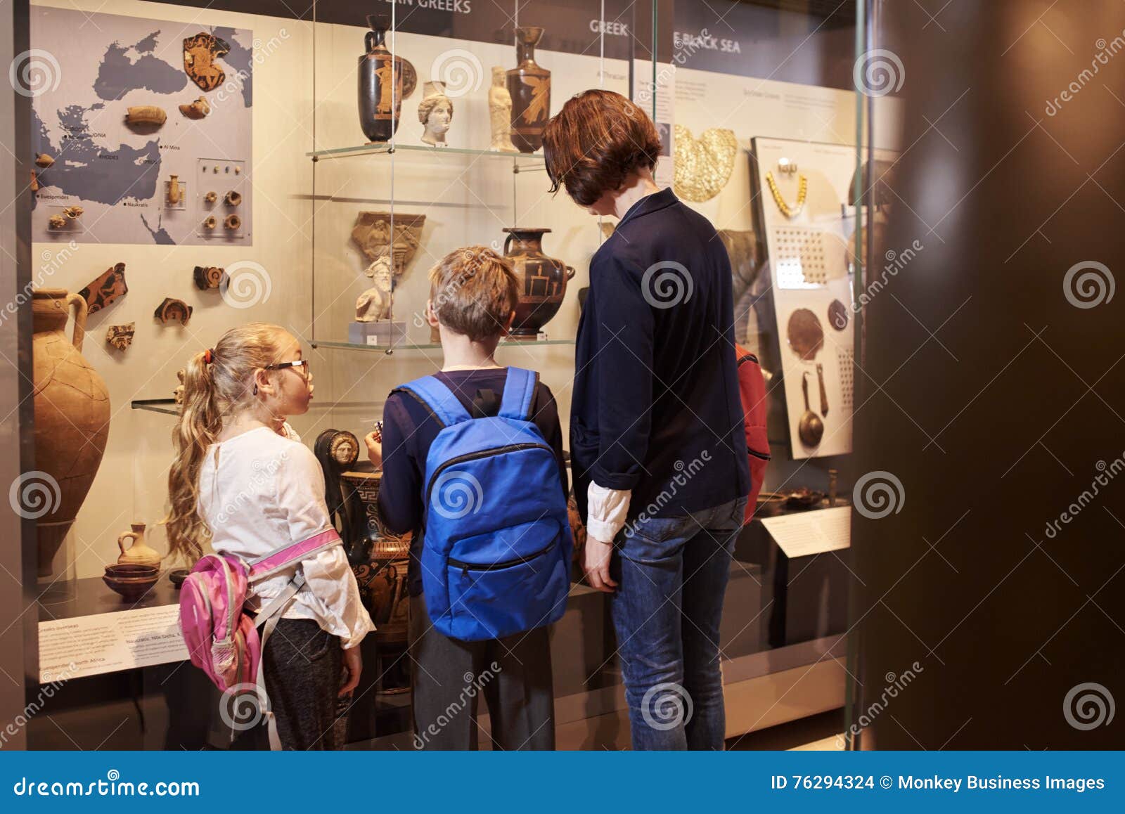 Teacher and Pupils Looking at Artifacts on Display in Museum Editorial ...