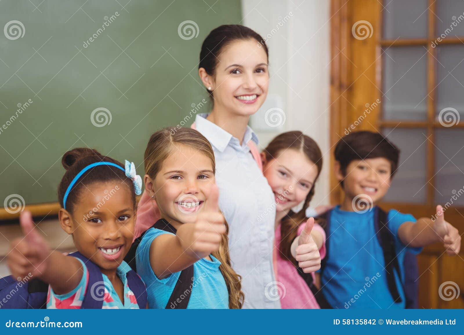 Teacher and Pupils Smiling in Classroom Stock Photo - Image of ...