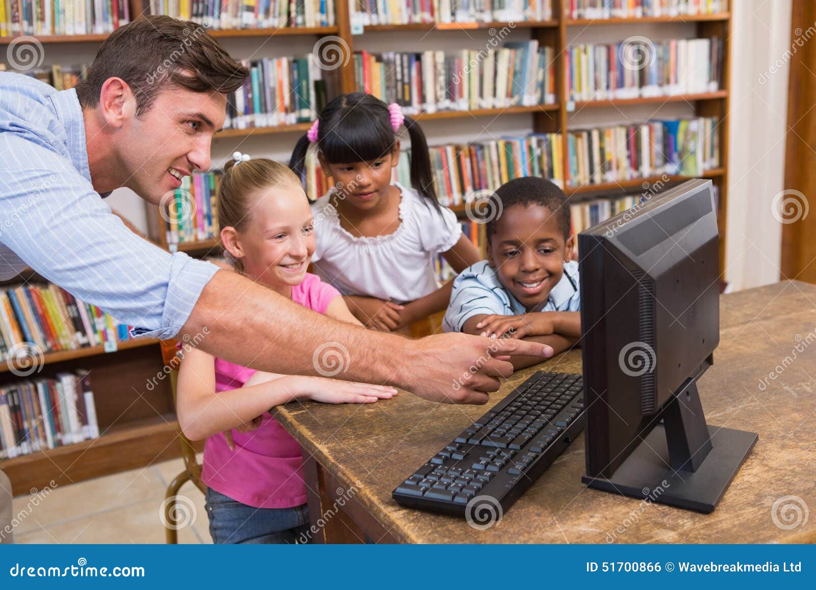 Teacher and Pupils Using Computer at Library Stock Photo - Image of ...