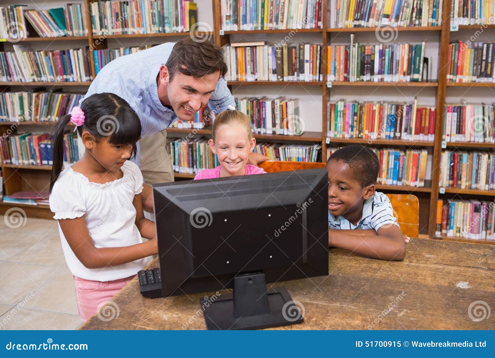Teacher and Pupils Using Computer at Library Stock Image - Image of ...