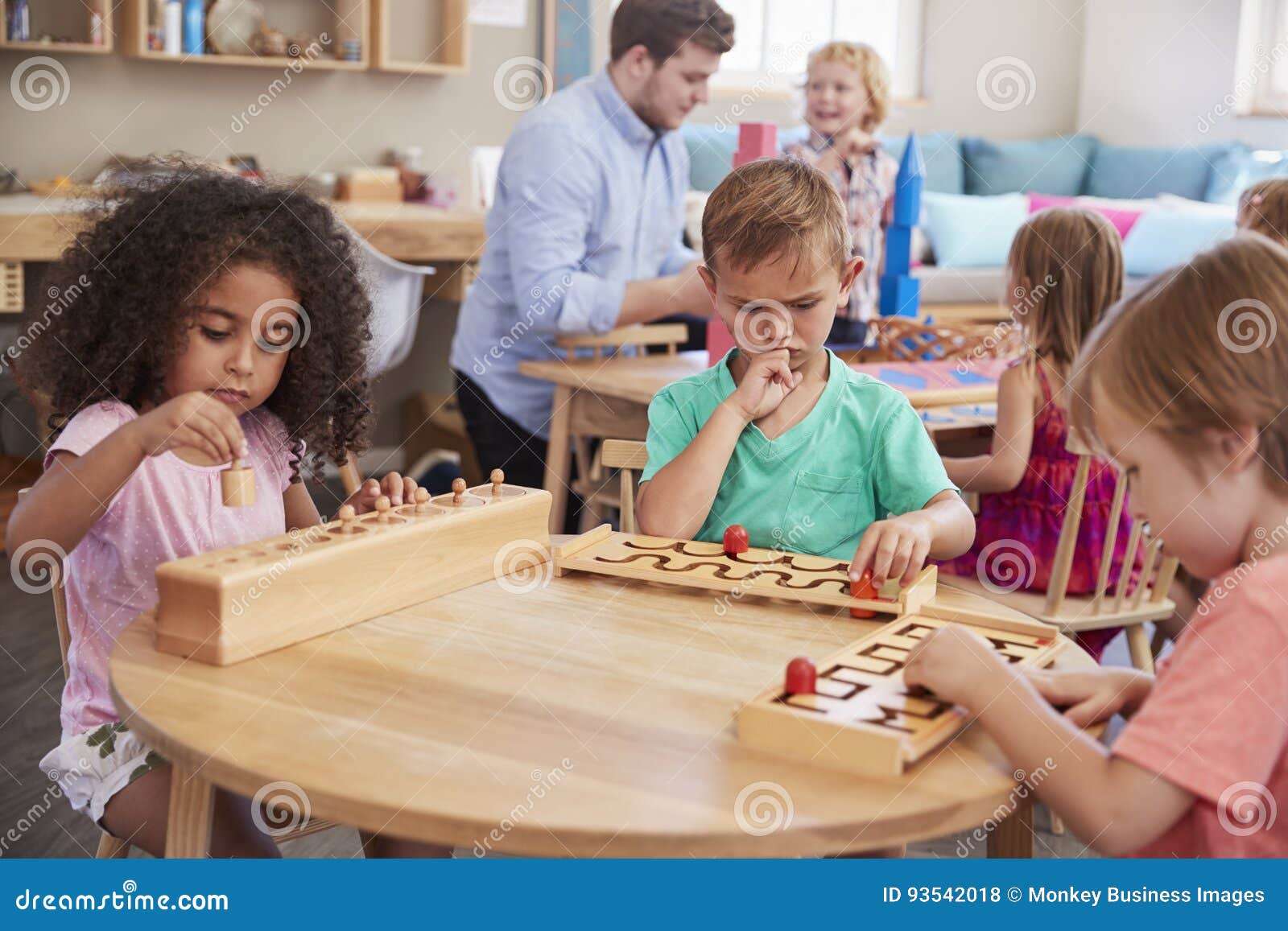 Teacher and Pupils Working at Tables in Montessori School Stock Photo ...