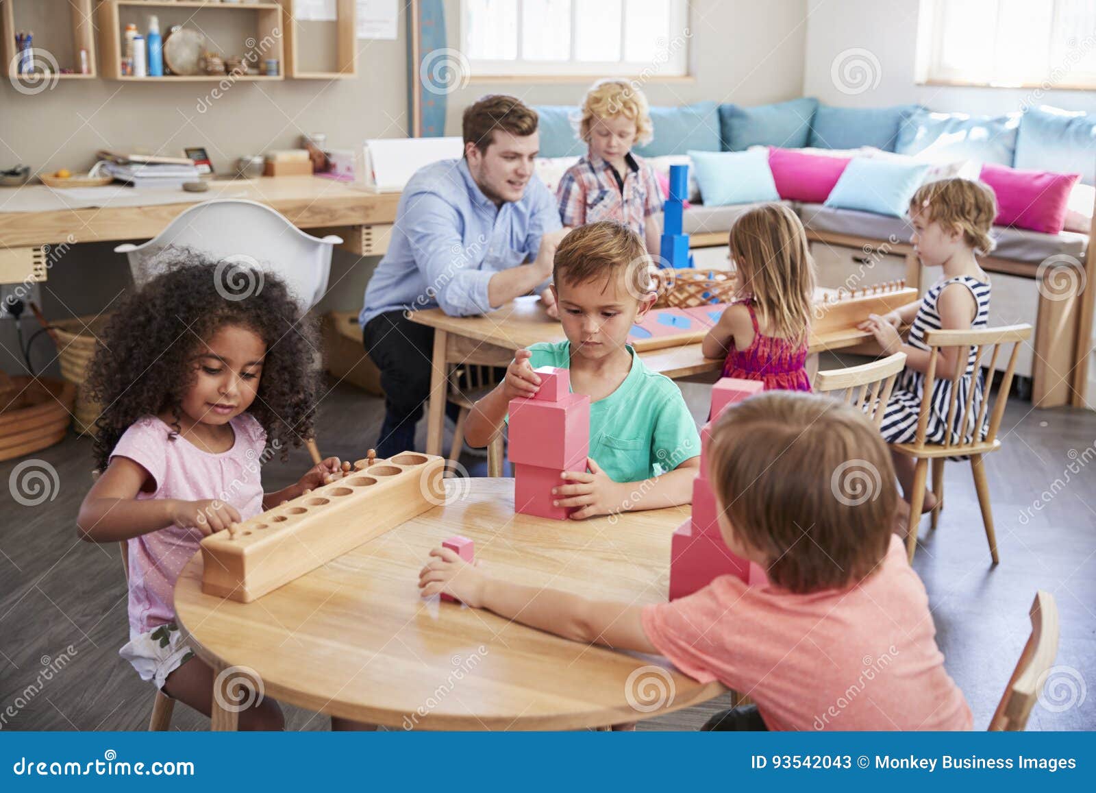 Teacher And Pupils Working At Tables In Montessori School Royalty-Free ...