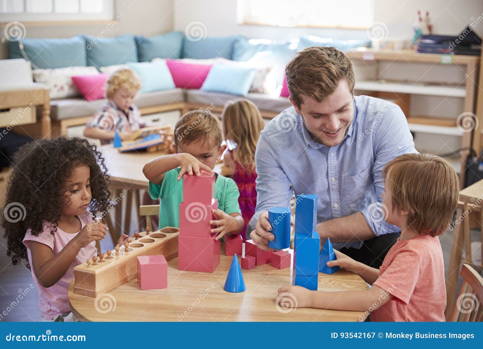 Teacher and Pupils Working at Tables in Montessori School Stock Image ...
