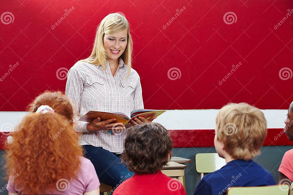Teacher Reading from Book in Class Stock Photo - Image of young, school ...