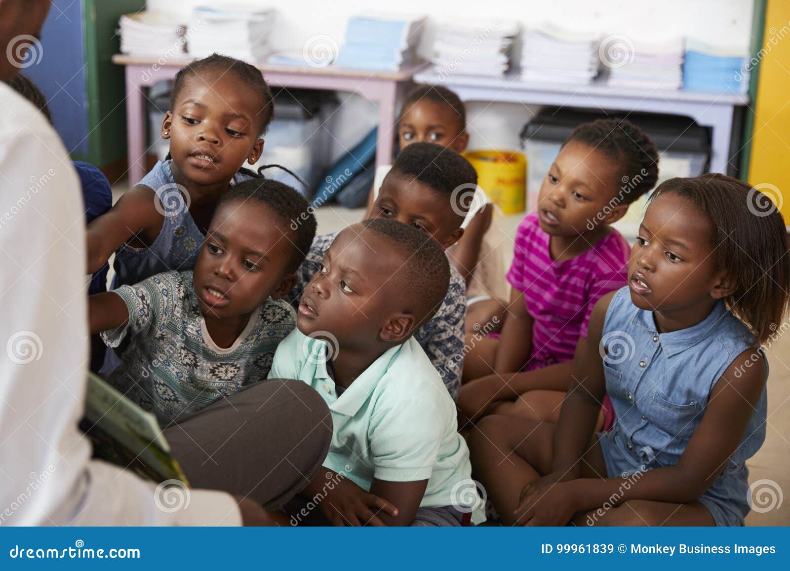 Teacher Reading Book To Elementary School Children in Class Stock Image ...