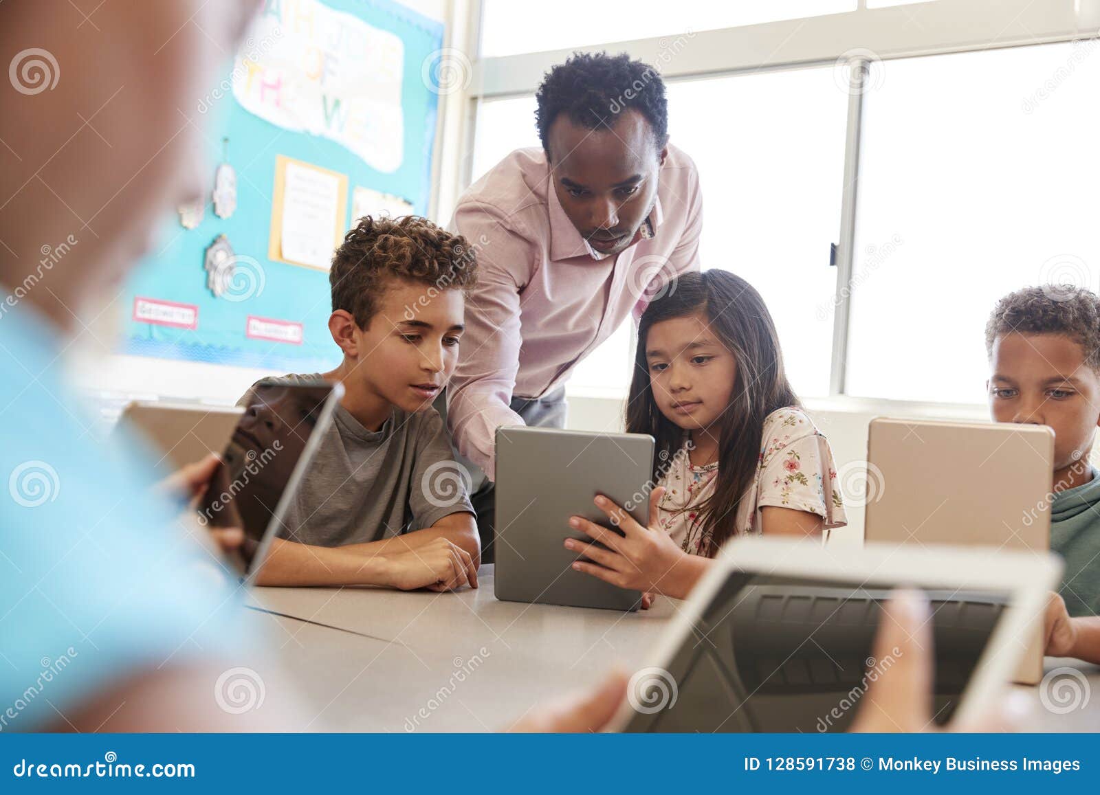 Teacher among School Kids Using Computers in Class Stock Photo - Image ...
