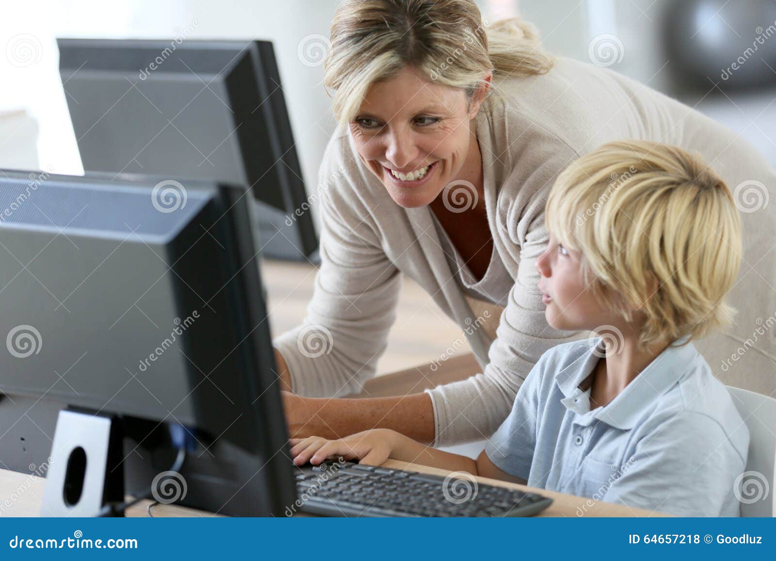 Teacher with Schoolboy on Computer Stock Photo - Image of children ...