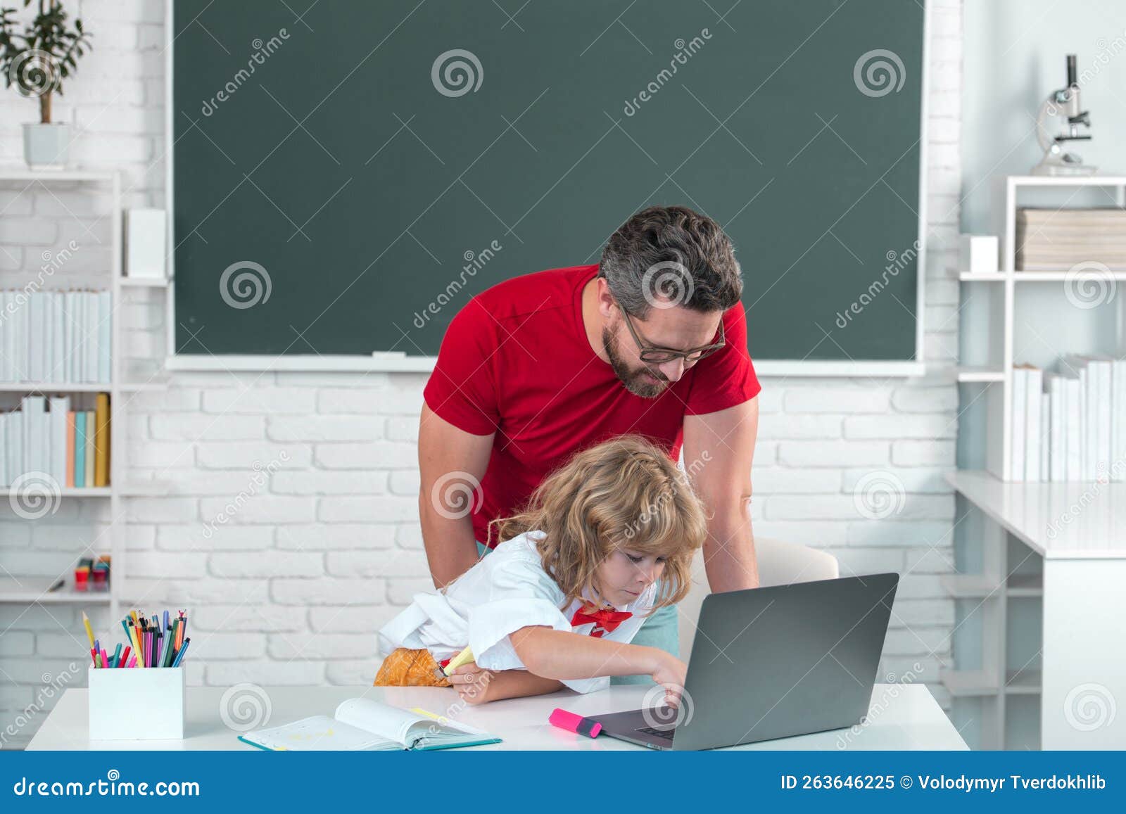 Teacher and Schoolboy Learning in Class at School. Pupil of Primary ...