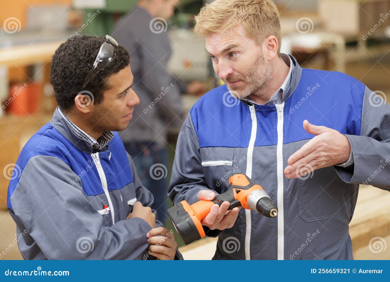 Teacher Showing Drill To Carpentry Student Stock Image - Image of ...