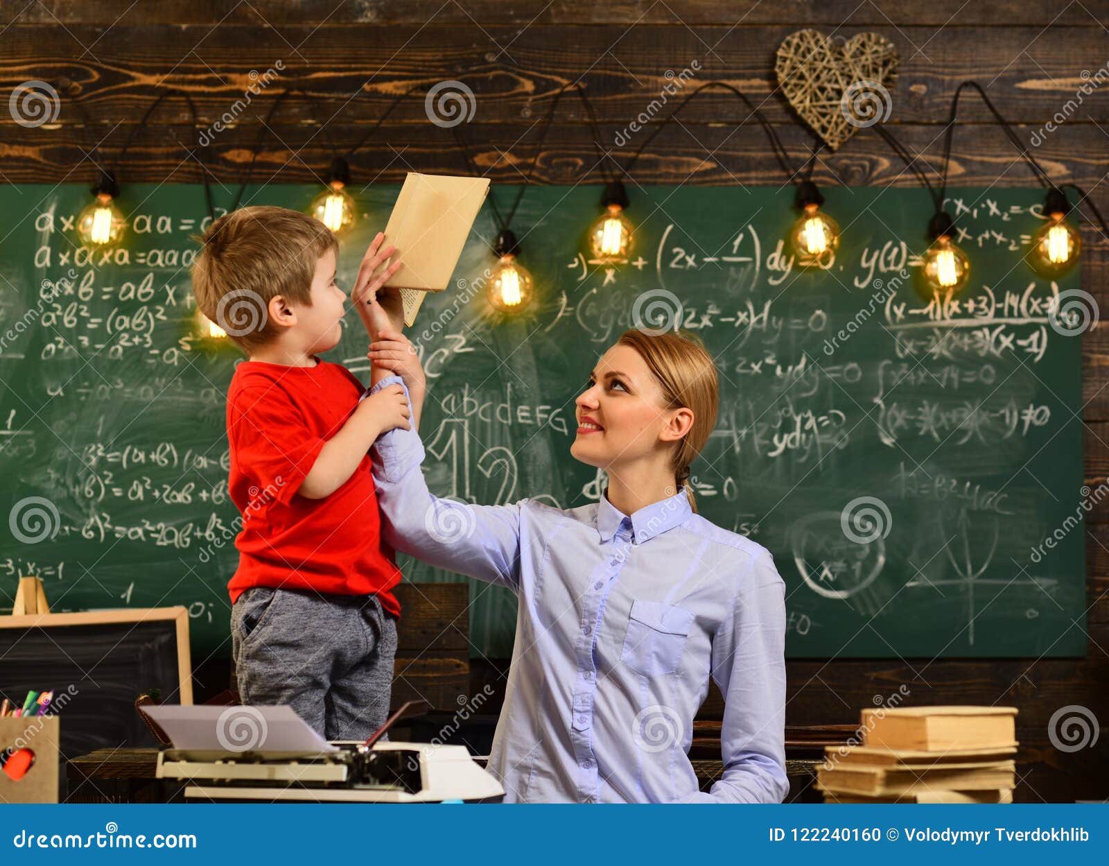 Teacher is Sitting at the Table in Classroom, Talented Coach during ...