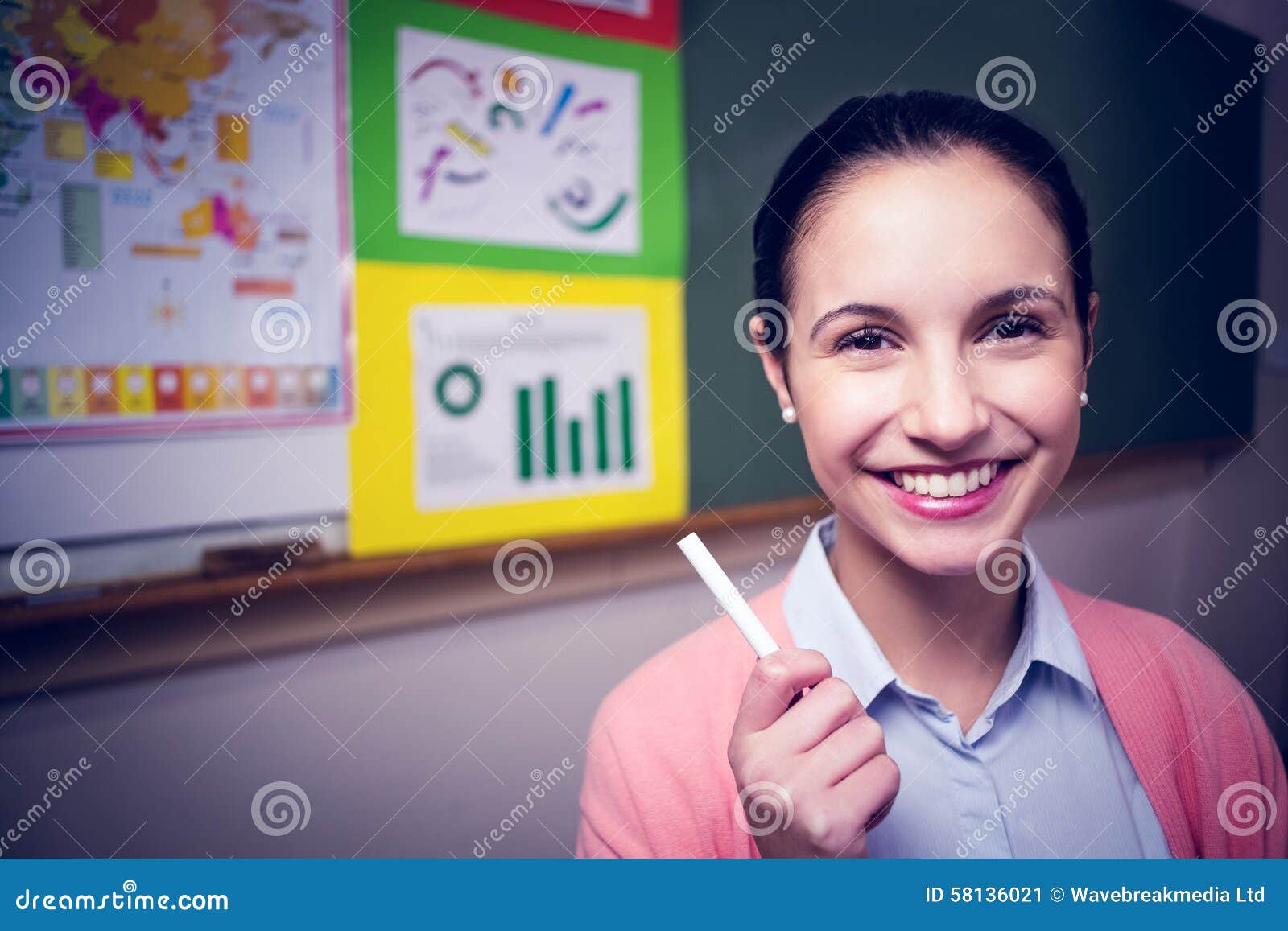 Teacher Smiling in Classroom Stock Image - Image of brunette, portrait ...
