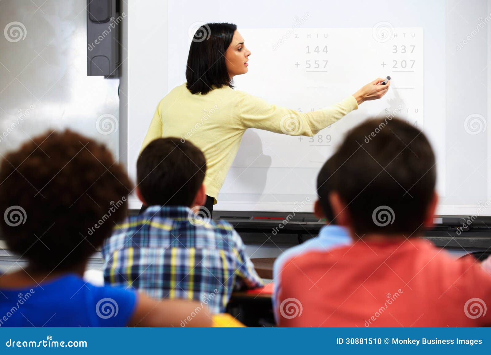 Teacher Standing in Class Using Interactive Whiteboard Stock Photo ...
