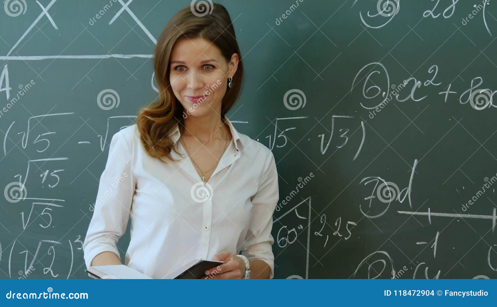 Teacher Standing in Front of Class Asking Question and Smiling . Stock ...