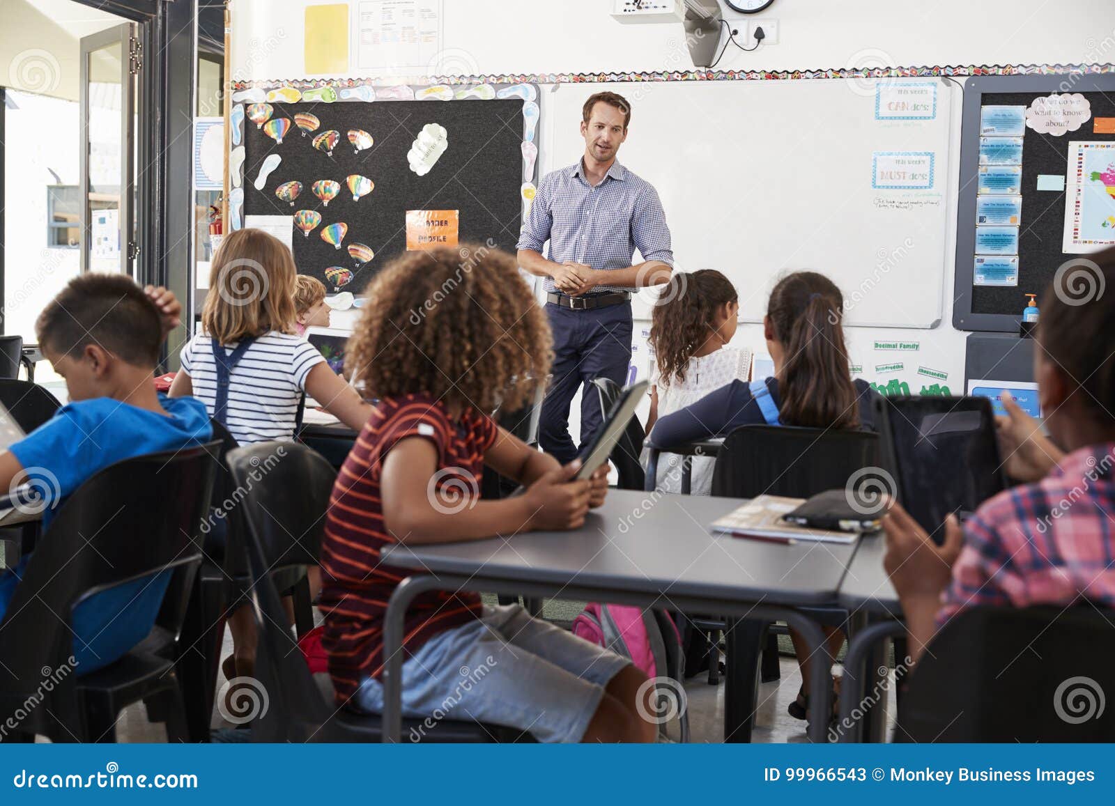 Teacher Standing In Front Of Elementary School Class Stock Image