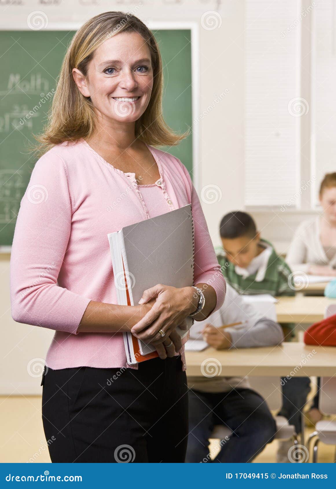 Teacher Standing with Notebook in Classroom Stock Image - Image of ...