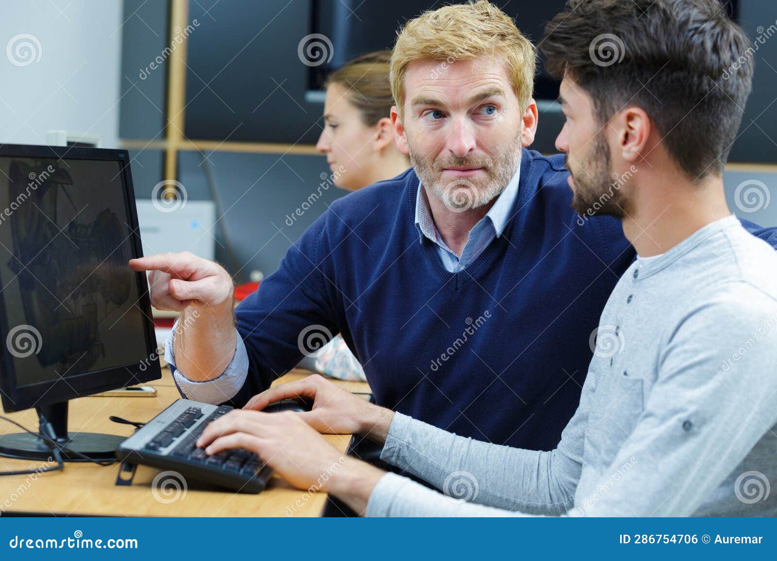 Teacher with Student in Apprenticeship Attending Computing Class Stock ...