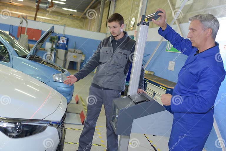 Teacher and Student in Auto Mechanics Training Class Stock Image ...