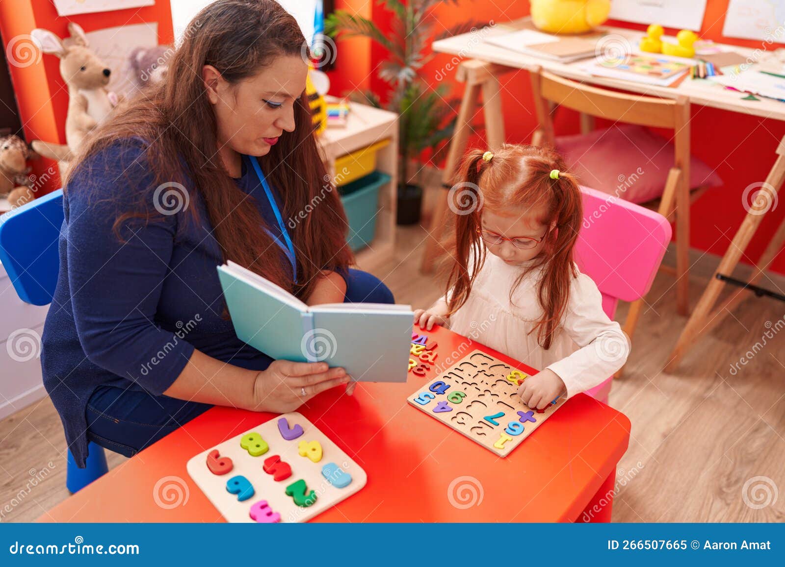 Teacher and Student Playing with Maths Puzzle Game Reading Book at ...