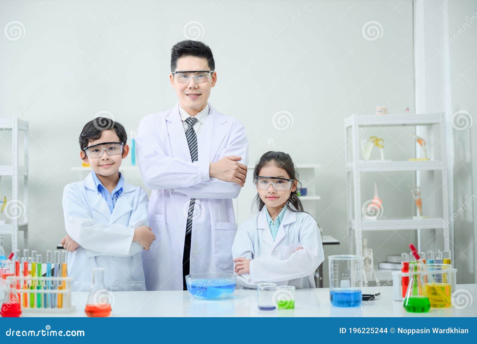 Teacher and Students are Looking at the Camera while Doing Science ...