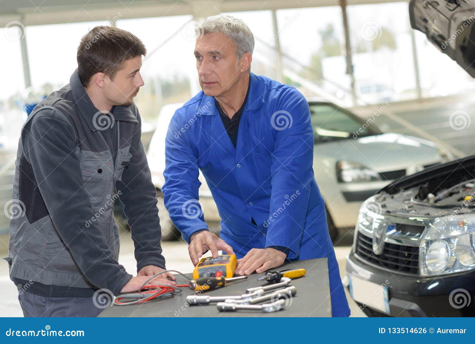 Teacher with Students in Mechanics Working Stock Photo - Image of ...