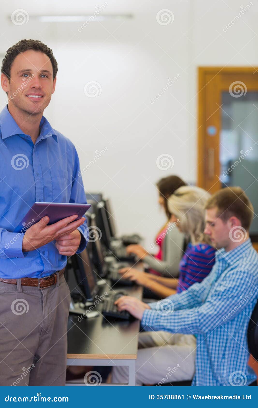Teacher with Students Using Computers in Computer Room Stock Image ...