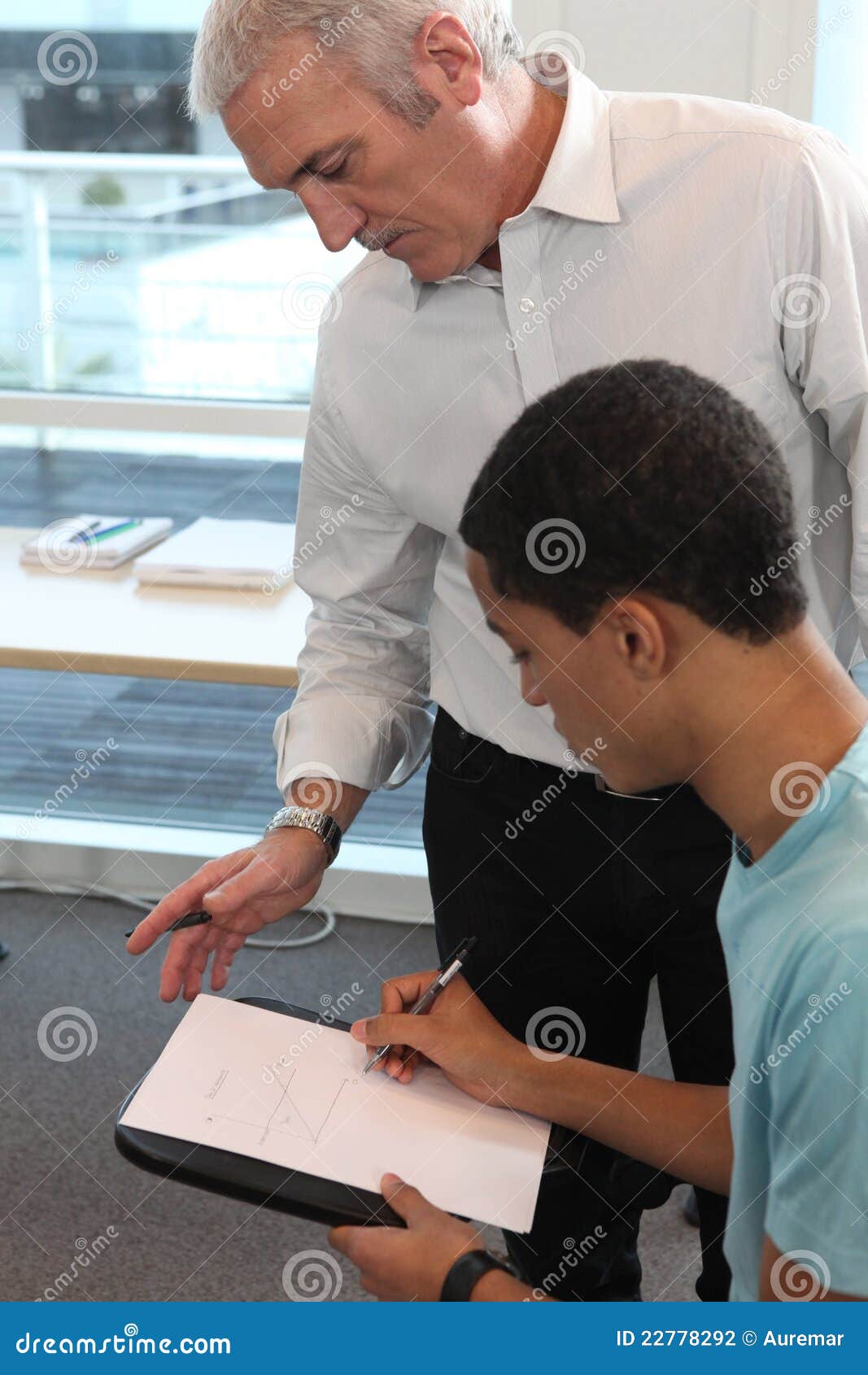 Teacher Supervising His Student S Work Stock Photo - Image of ...