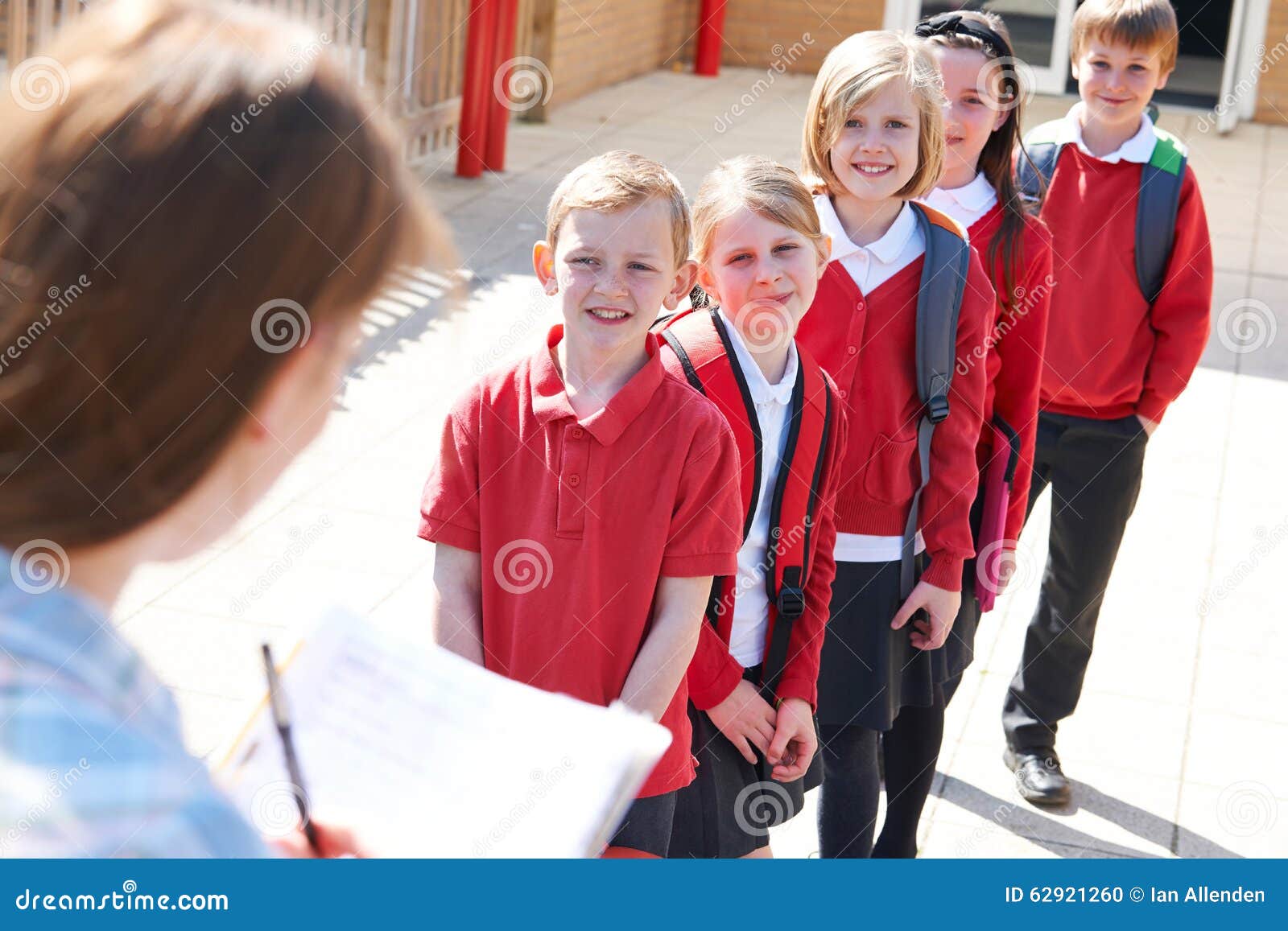 Teacher Taking School Register in Playground Stock Photo - Image of ...