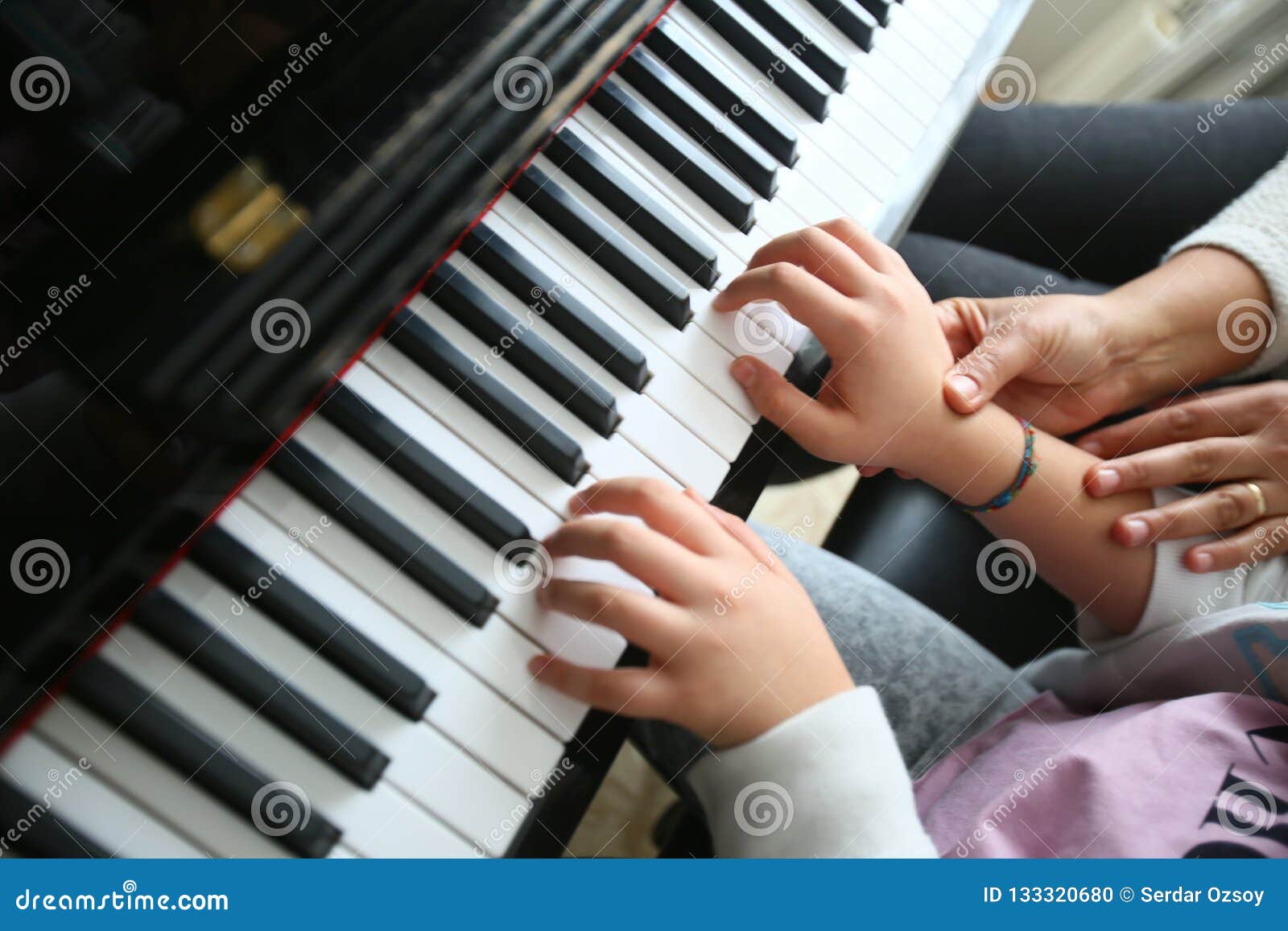 A Teacher Teaches Playing Piano Her Student. Stock Photo - Image of ...