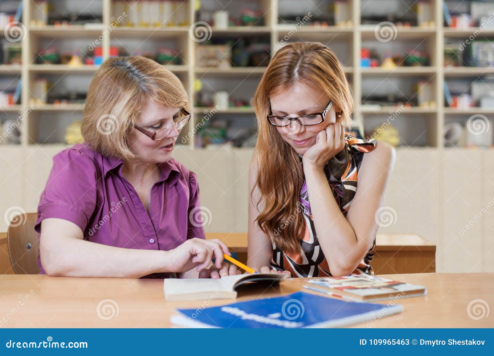 Teacher Teaches a Student at a Table in the Classroom Stock Image ...