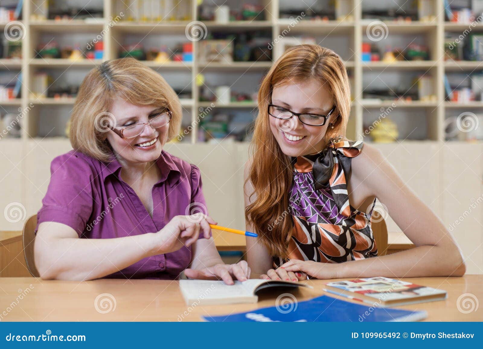 The Teacher Teaches Lessons With A Student Sitting At The Table Stock ...