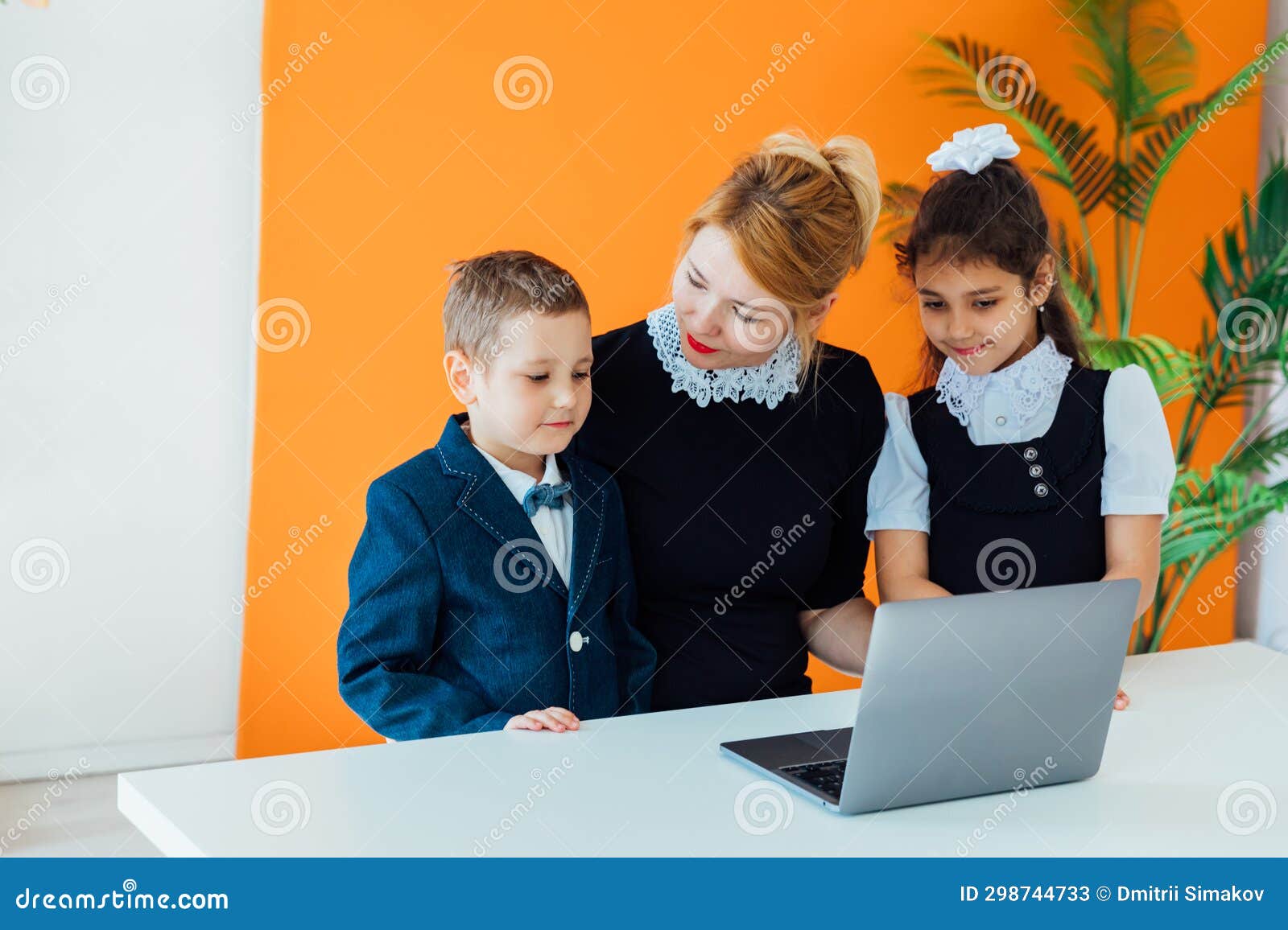 Teacher Teaching Boy and Girl on Computer at School Stock Image - Image ...