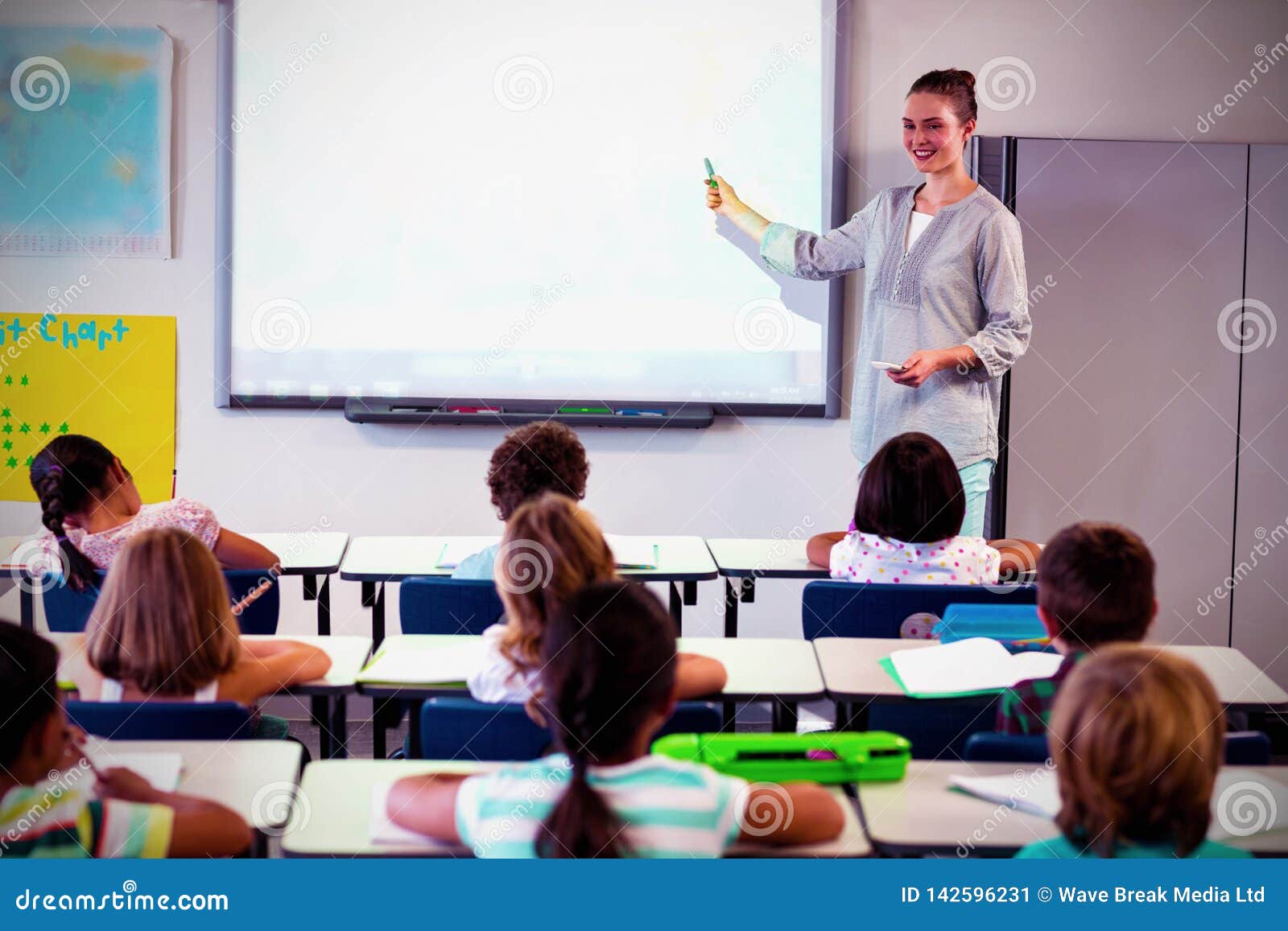 Teacher Teaching Children Using Projector Stock Image - Image of career ...