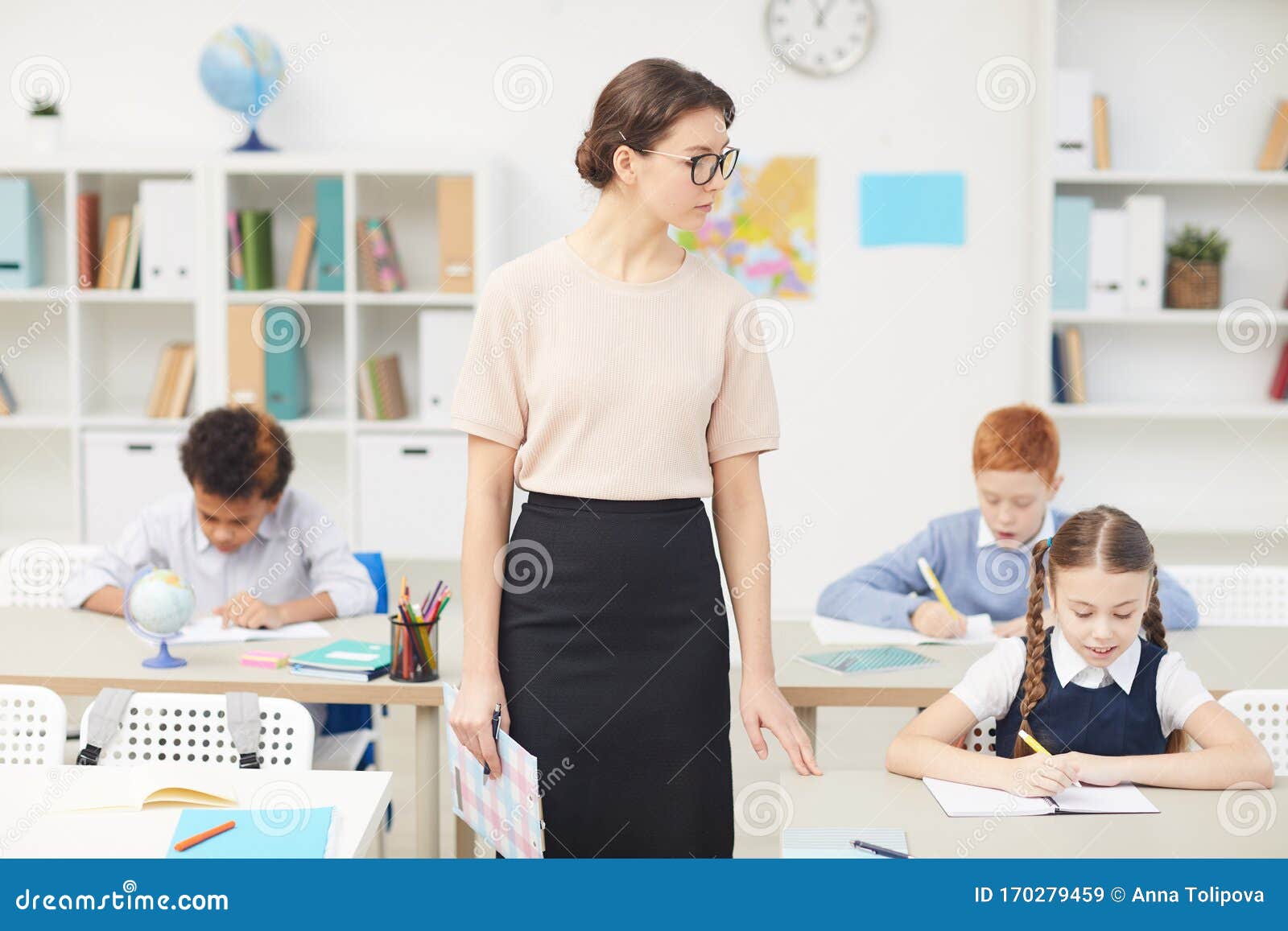 Teacher Teaching Elementary Students Stock Image - Image of sitting ...