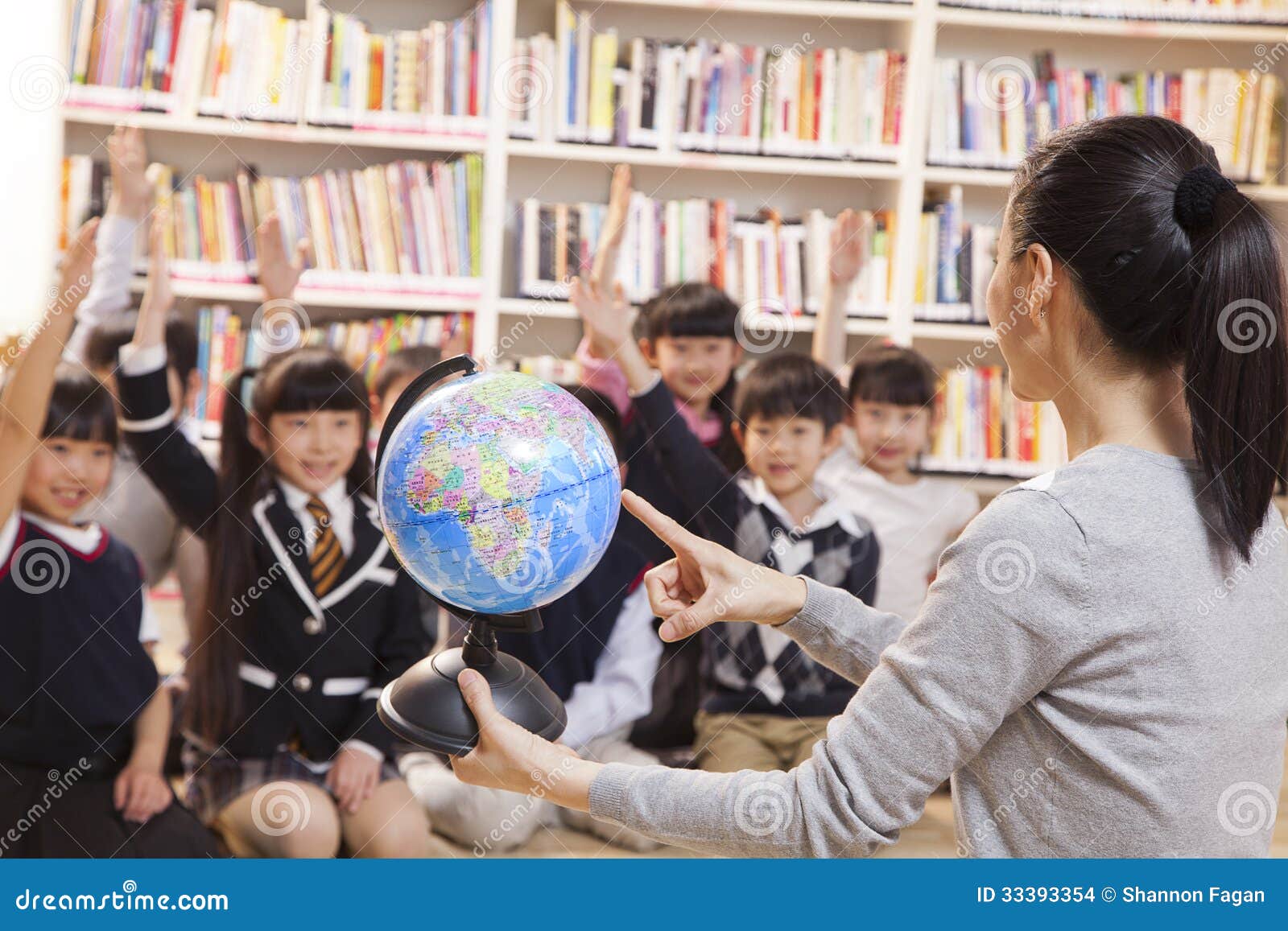 Teacher Teaching Geography To Schoolchildren with a Globe Stock Photo ... Teacher Teaching Geography To Schoolchildren with a Globe Stock Photo ...