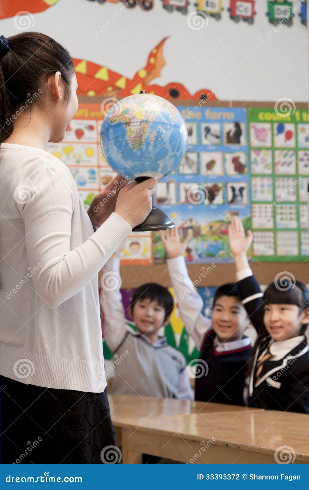 Teacher Teaching Geography To Schoolchildren with a Globe Stock Photo ... Teacher Teaching Geography To Schoolchildren with a Globe Stock Photo ...