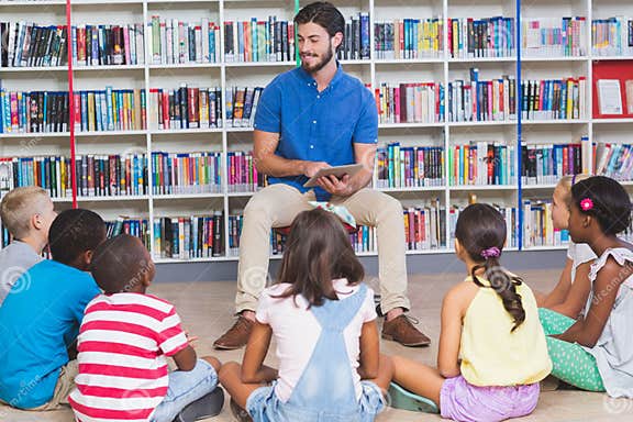 Teacher Teaching Kids on Digital Tablet in Library Stock Image - Image ...