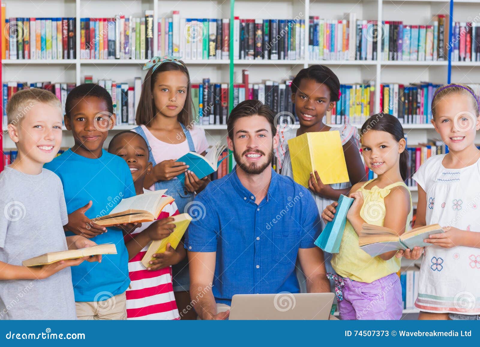 Teacher Teaching Kids on Laptop in Library Stock Image - Image of ...